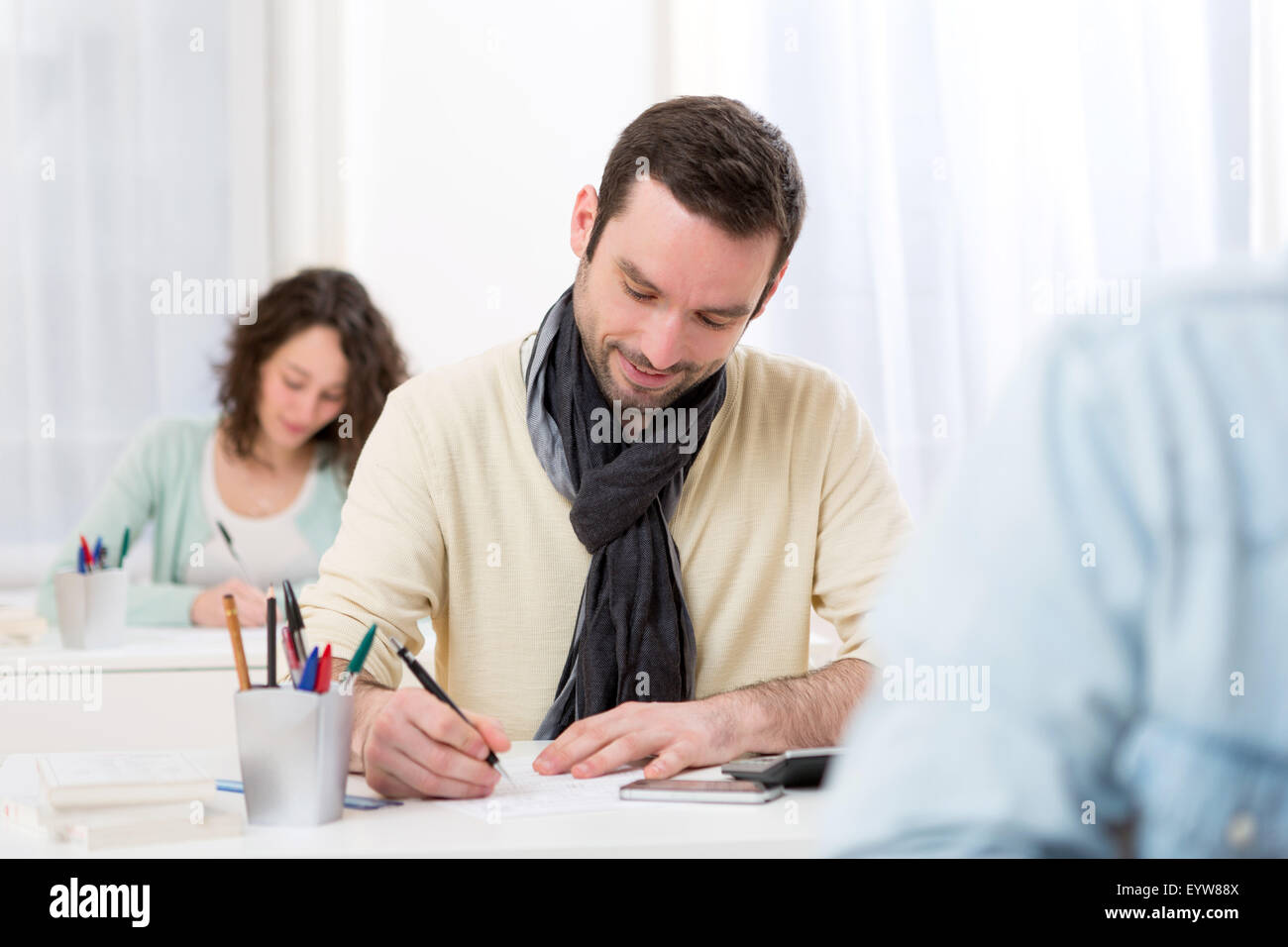 Woman taking exam desk hi-res stock photography and images - Alamy