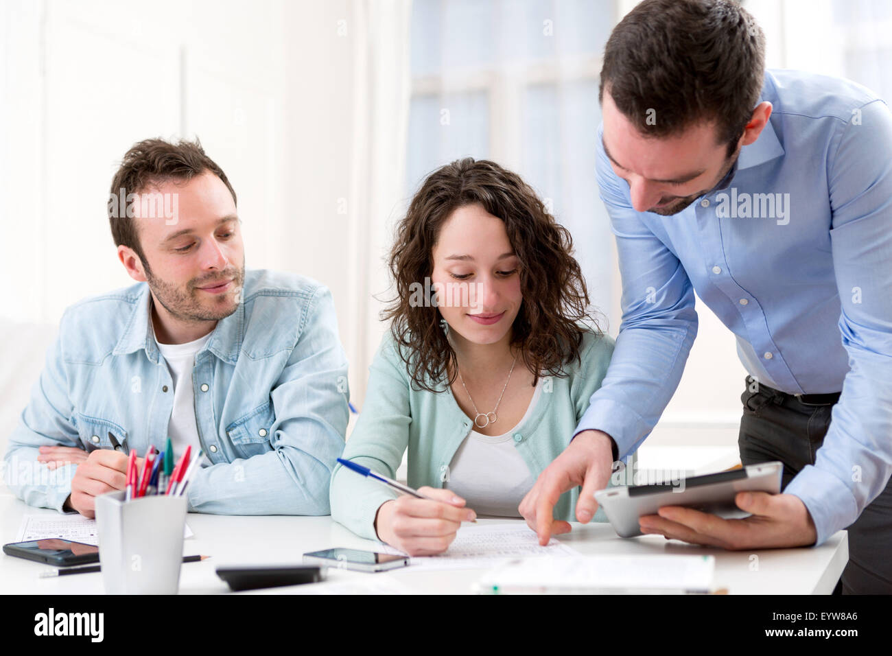 View of Two interns working together assisted by their course ...