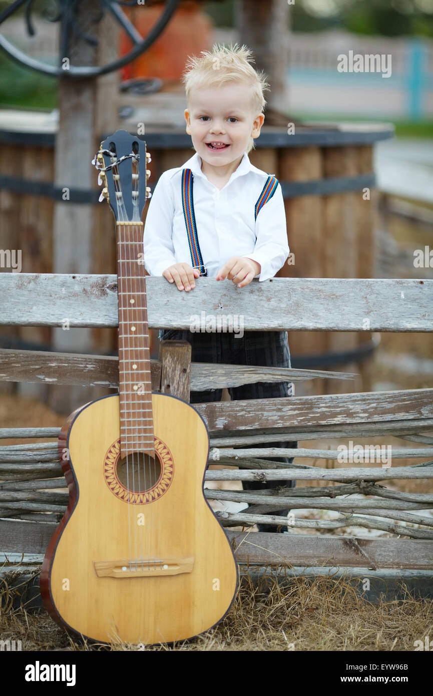 little boy with guitar on location Stock Photo - Alamy