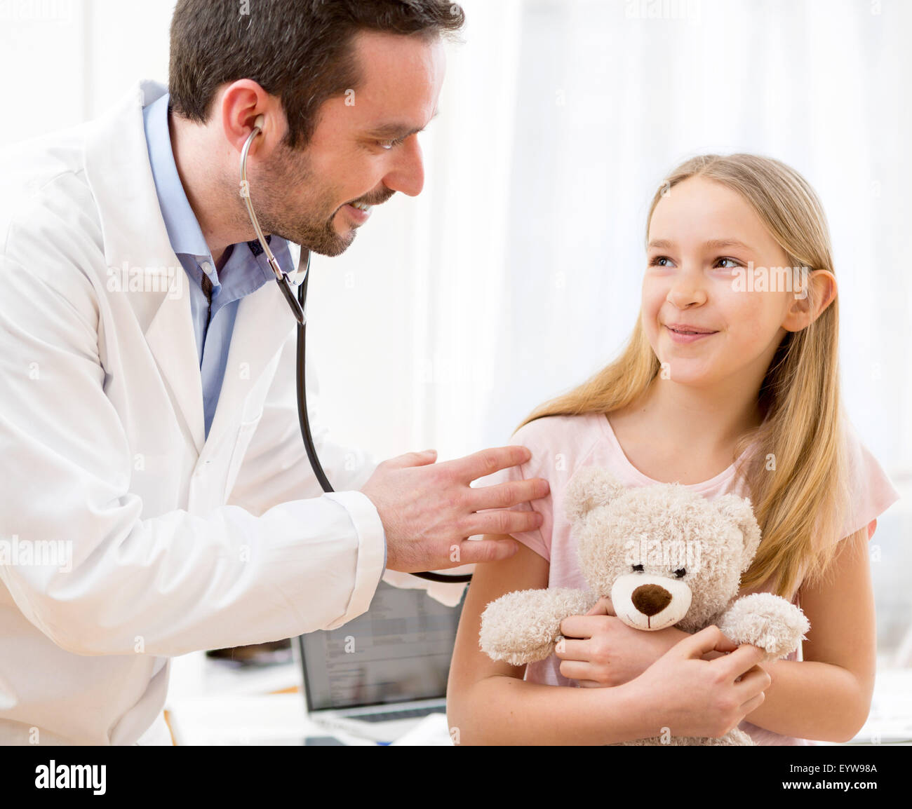 View of a Doctor listening heart beatment of little girl Stock Photo ...