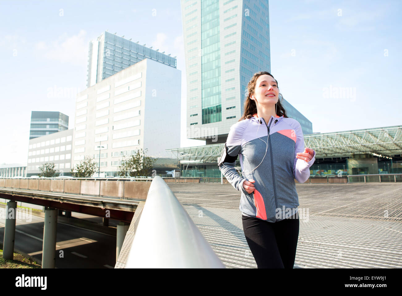 View of a Young attractive woman running downtown Stock Photo - Alamy