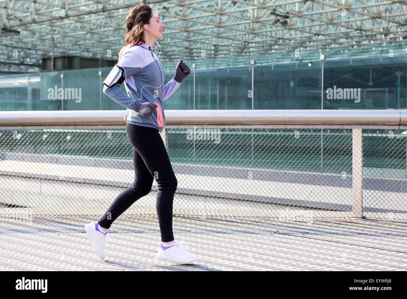 View of a Young attractive woman running downtown Stock Photo - Alamy