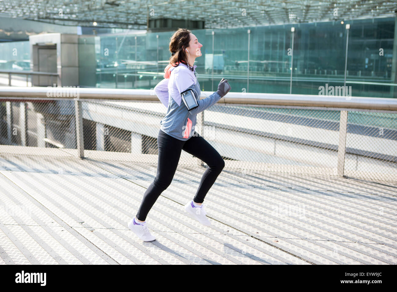 View of a Young attractive woman running downtown Stock Photo - Alamy