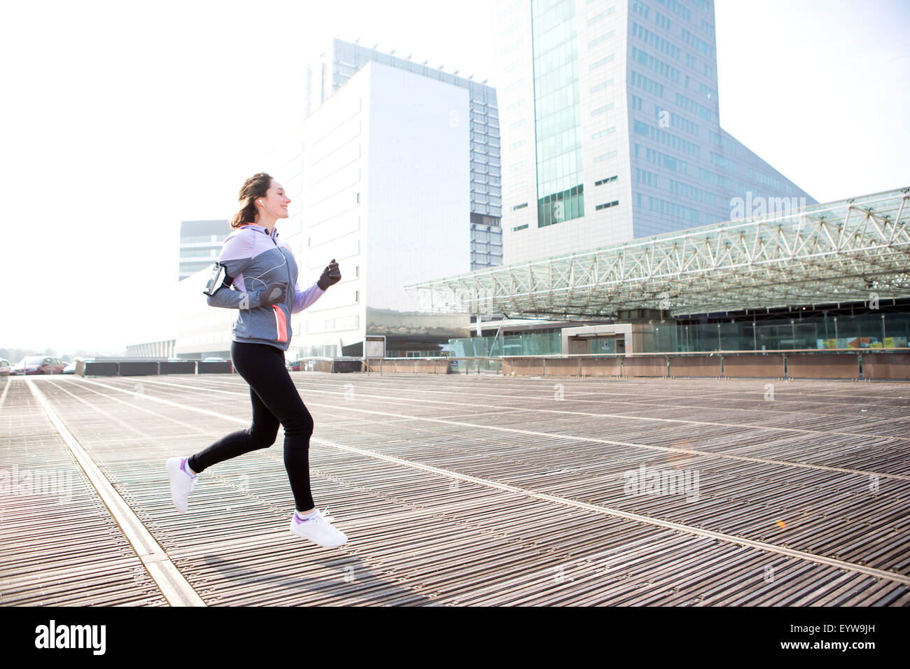 View of a Young attractive woman running downtown Stock Photo - Alamy