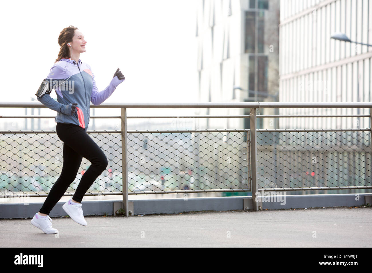 View of a Young attractive woman running downtown Stock Photo - Alamy