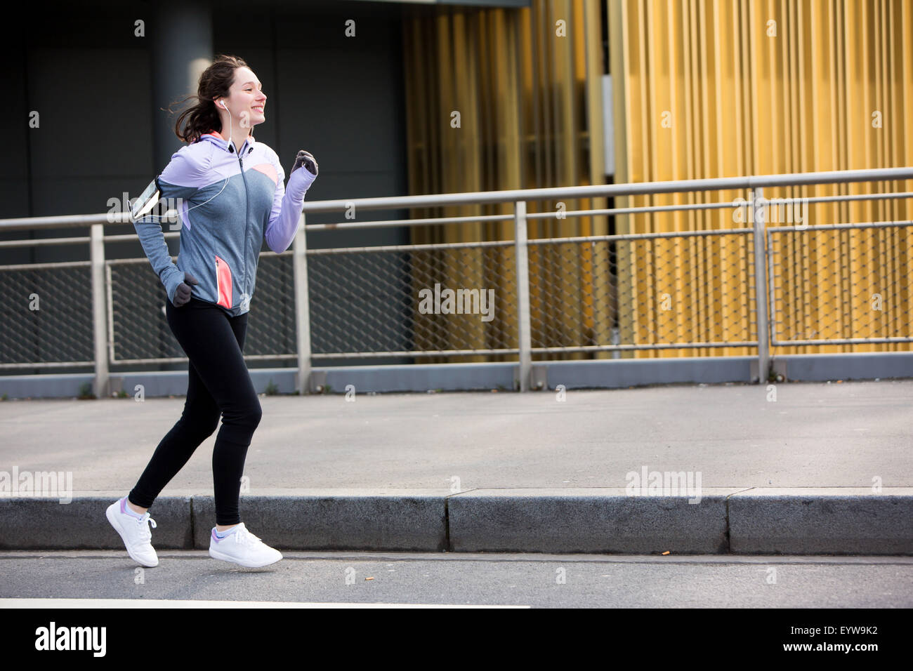 View of a Young attractive woman running downtown Stock Photo - Alamy