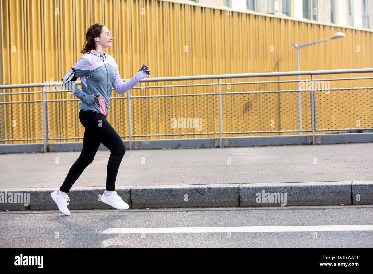 View of a Young attractive woman running downtown Stock Photo - Alamy