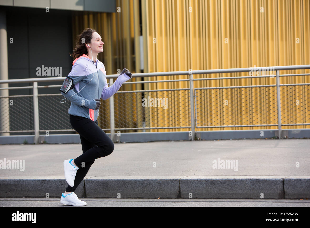View of a Young attractive woman running downtown Stock Photo - Alamy