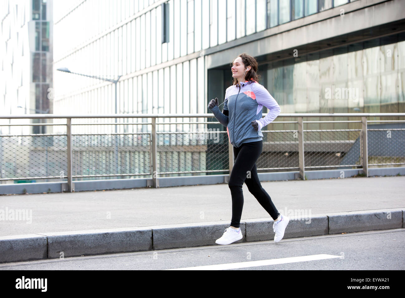 View of a Young attractive woman running downtown Stock Photo - Alamy