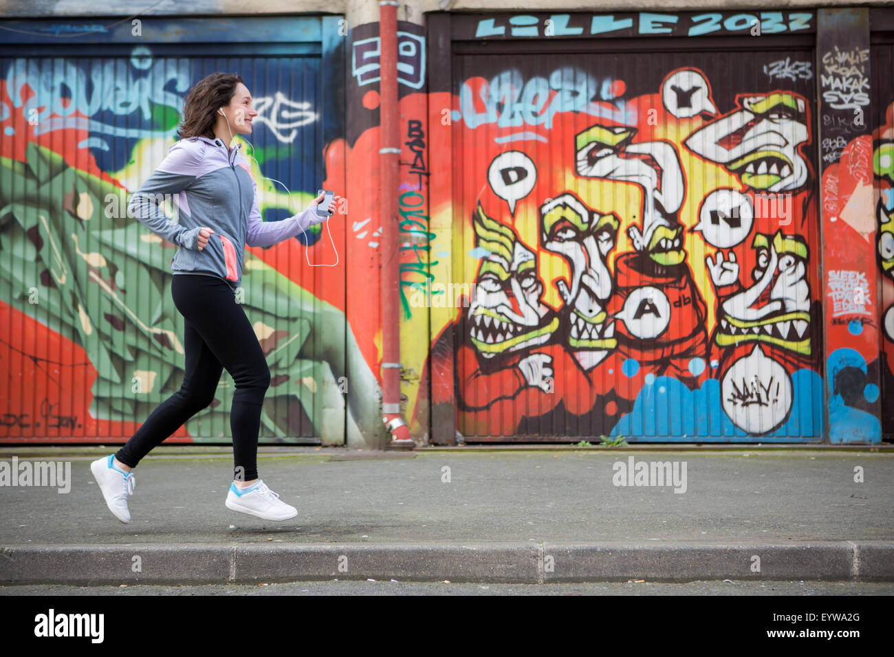 View of a Young attractive woman running downtown Stock Photo - Alamy