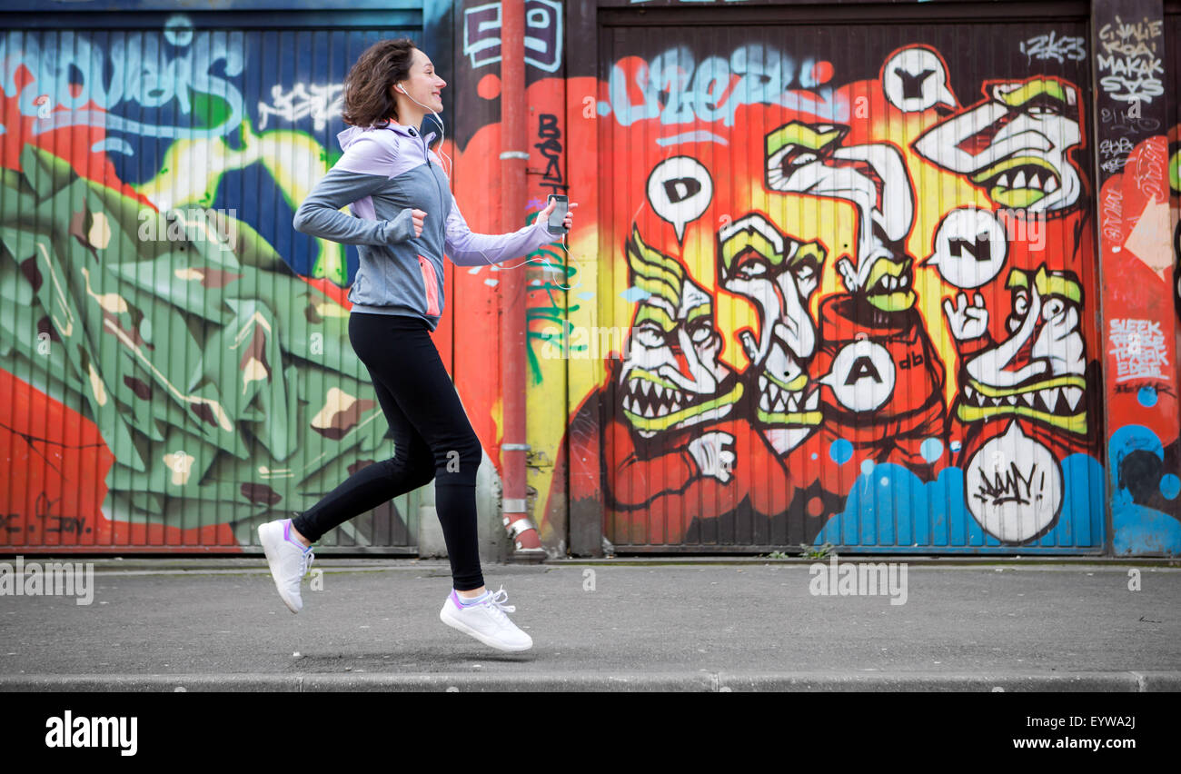 View of a Young attractive woman running downtown Stock Photo - Alamy