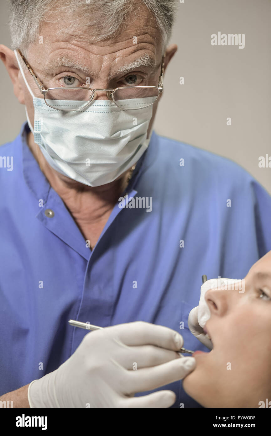 Portrait Dentist in action in office Stock Photo - Alamy