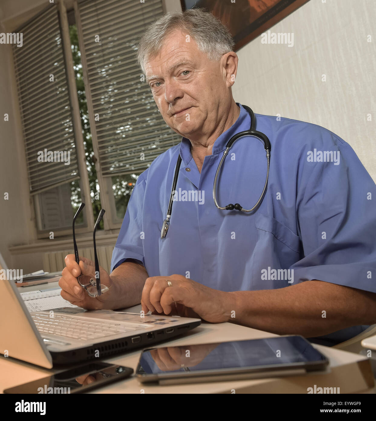 Portrait of smiling doctor at laptop in office Stock Photo - Alamy