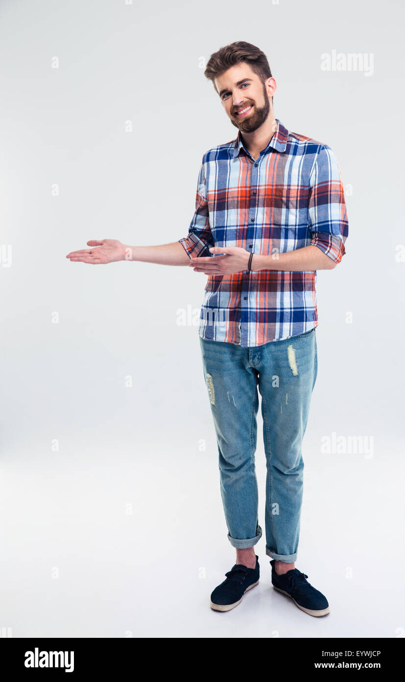 Full length portrait of a happy man showing welcome gesture isolated on ...