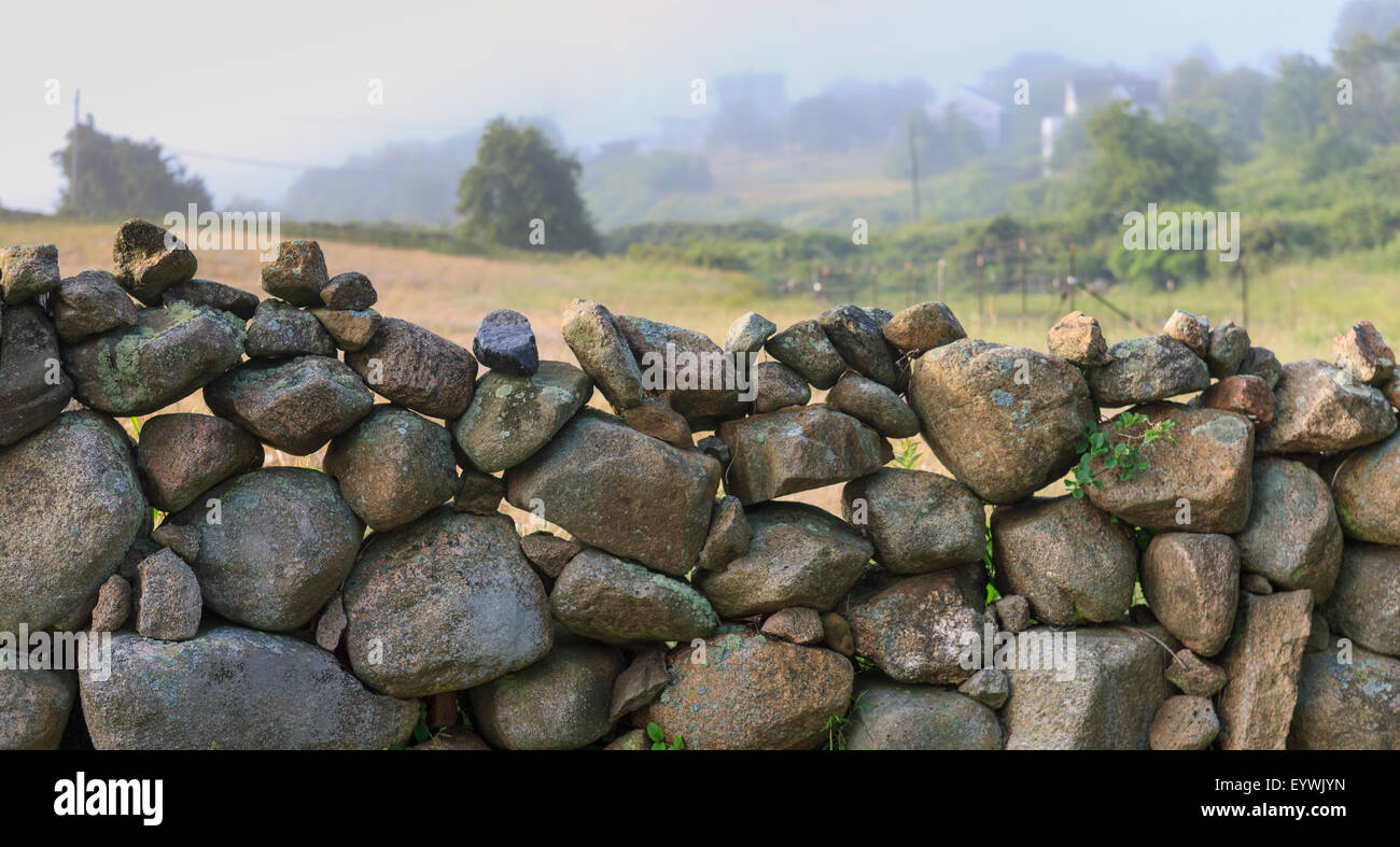 Rock wall and field Stock Photo - Alamy