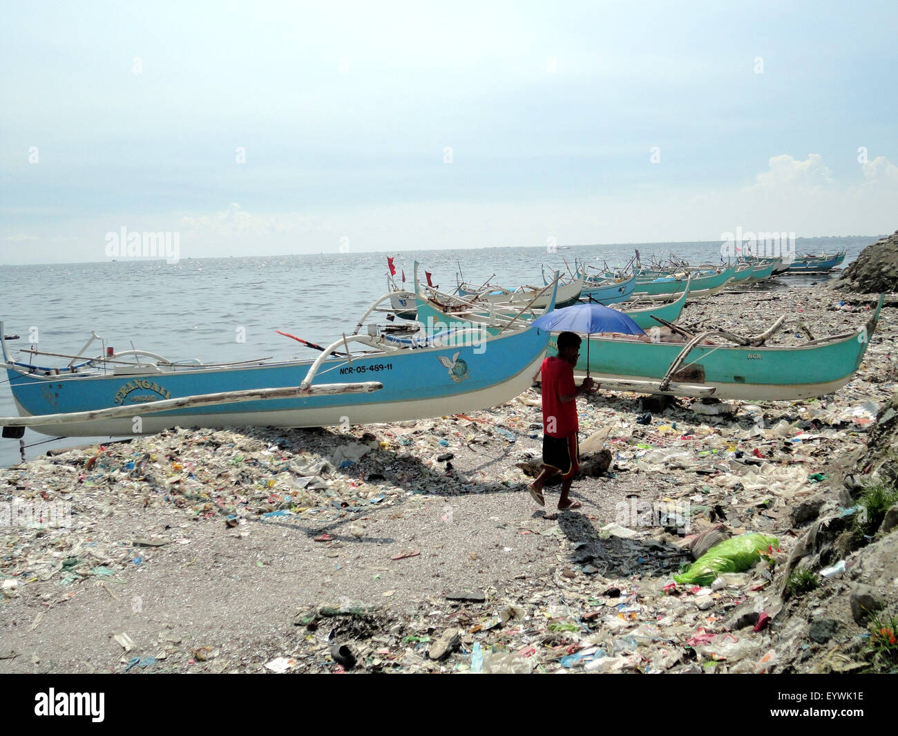 Navotas City, Philippines. 04th Aug, 2015. A Filipino man walks along ...