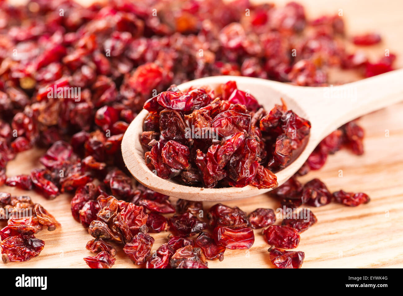 Dry red barberry spices in the wooden spoons Stock Photo - Alamy
