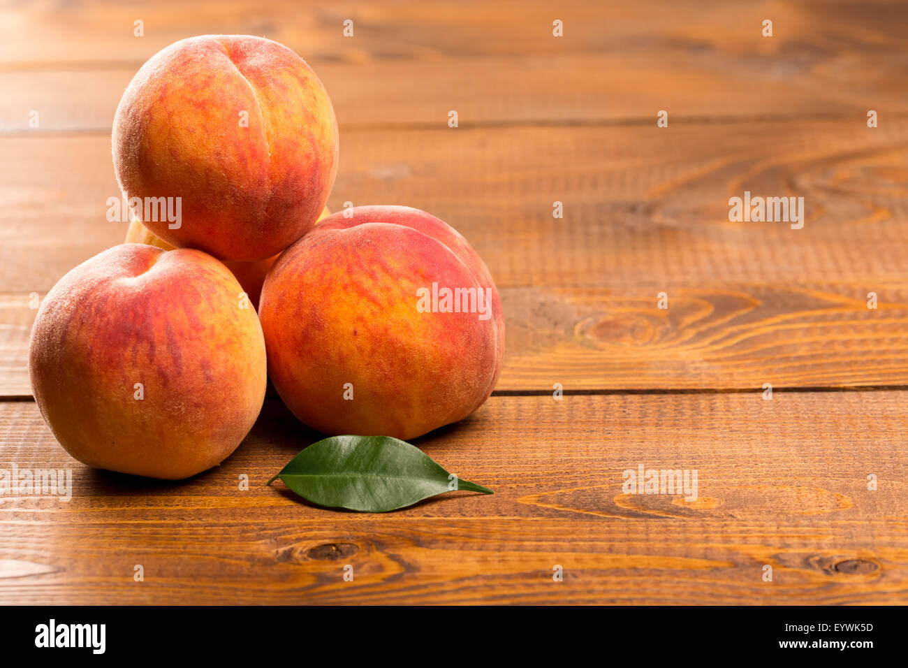 Peach on wood background Stock Photo - Alamy