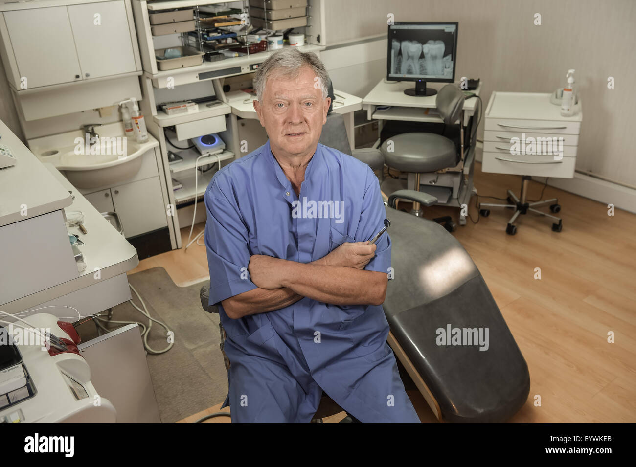 Dentist posing in his office Stock Photo - Alamy