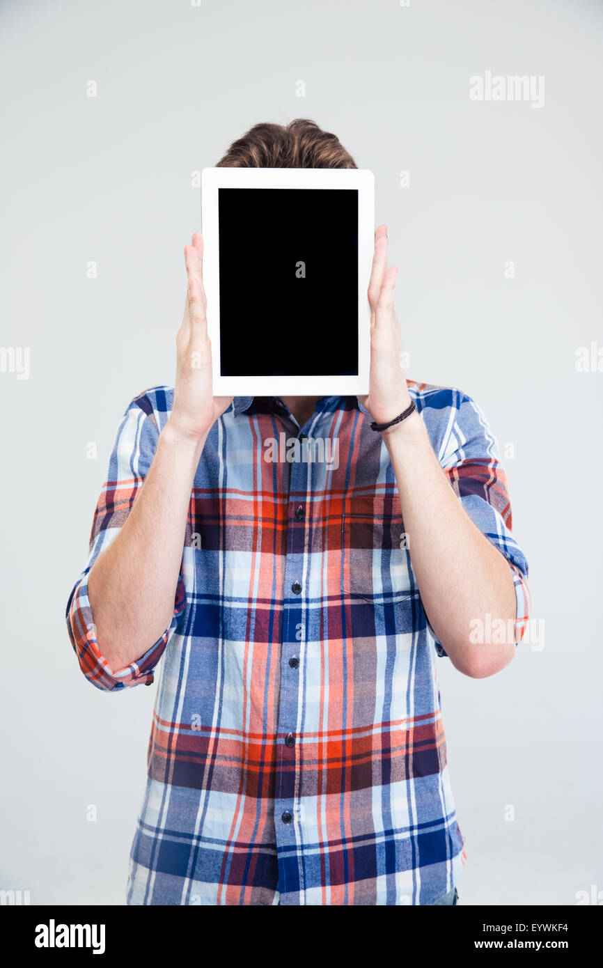 Man with tablet covering face hi-res stock photography and images - Alamy