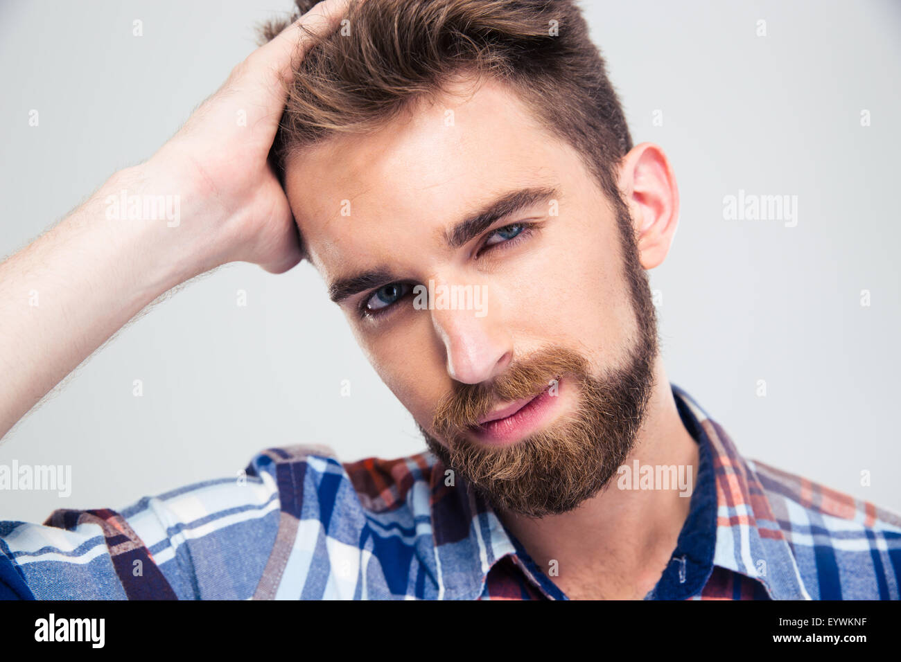Portrait of a handsome man looking at camera isolated on a white ...