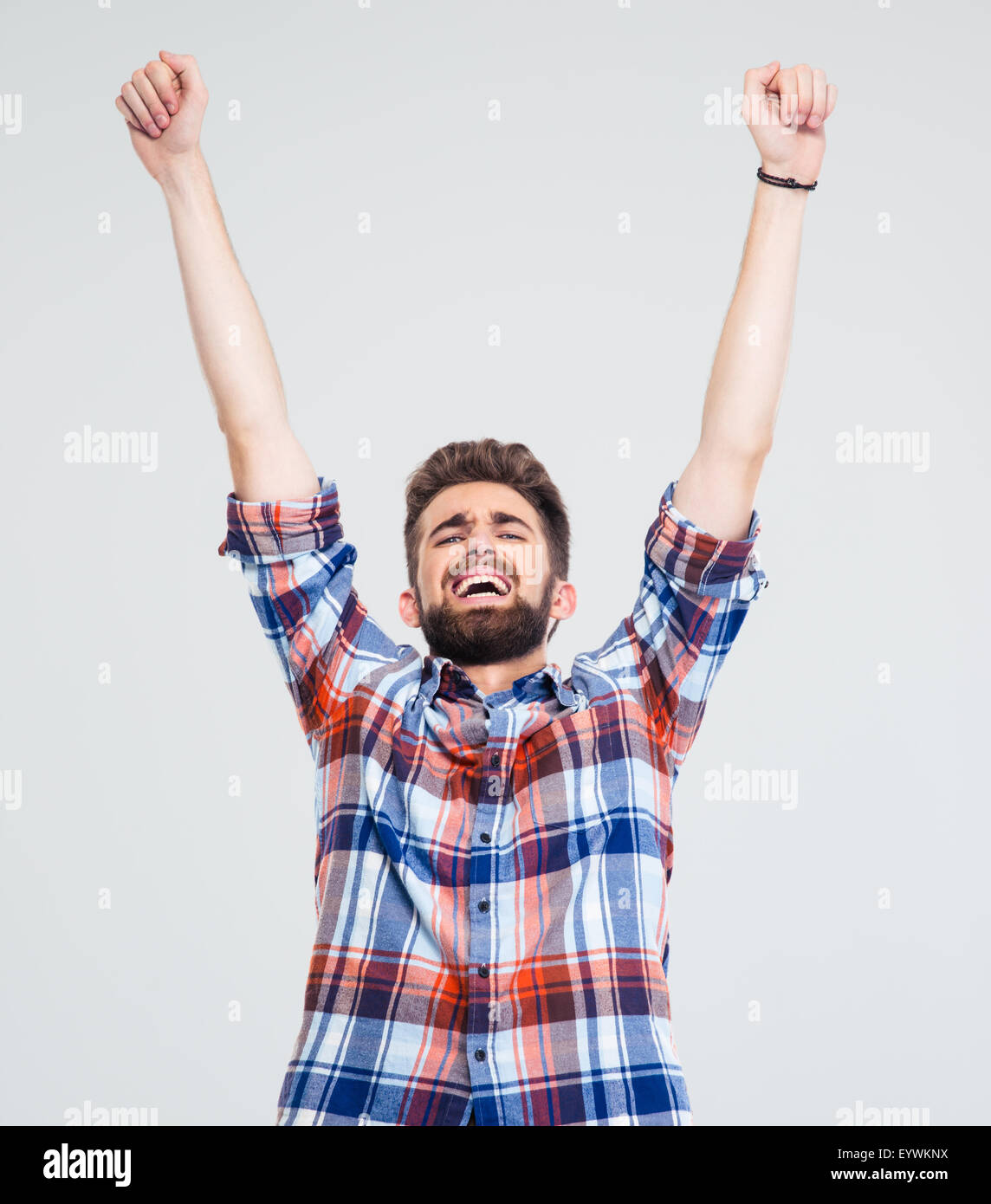 Cheerful young man celebrating his success isolated on a white ...