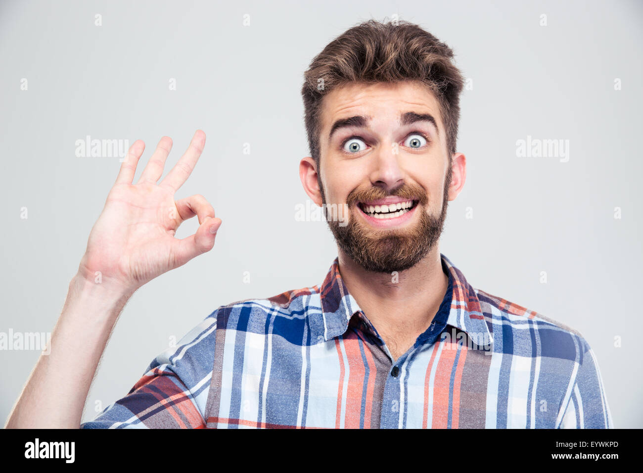 Funny man showing ok sign with fingers isolated on a white background ...