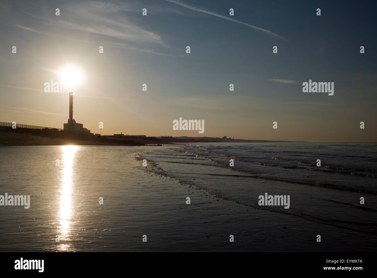 Morning sun over power station chimney, seashore, Southwick, Sussex ...