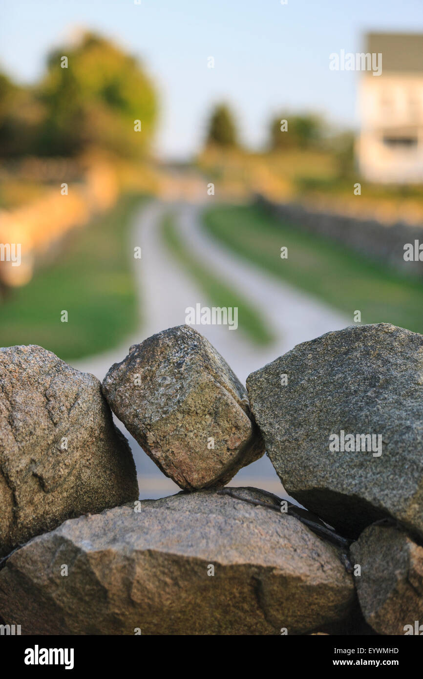 Stone wall with country road Stock Photo - Alamy