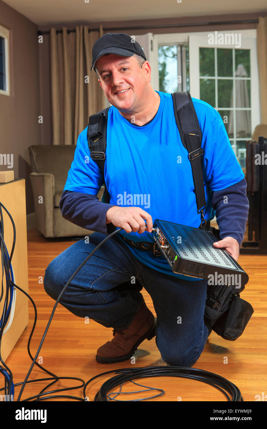 Service man connecting cable to modem box for home TV Stock Photo - Alamy