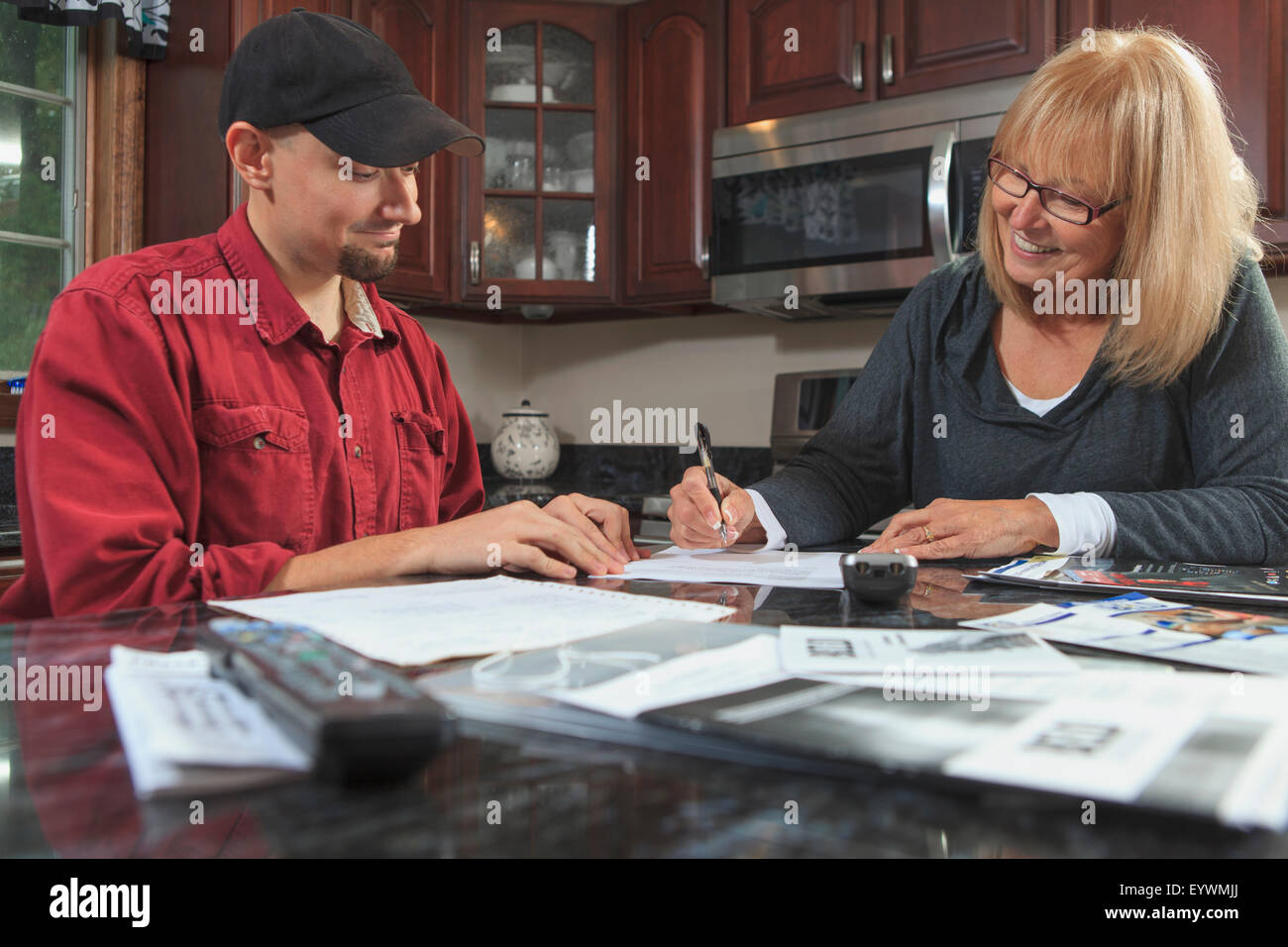 Cable installer doing contract paperwork with home owner Stock Photo ...