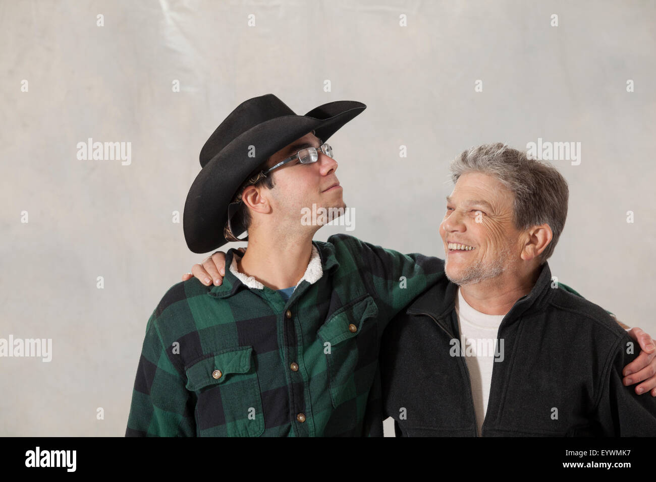 Young man with autism and his mentor looking at each other and smiling ...