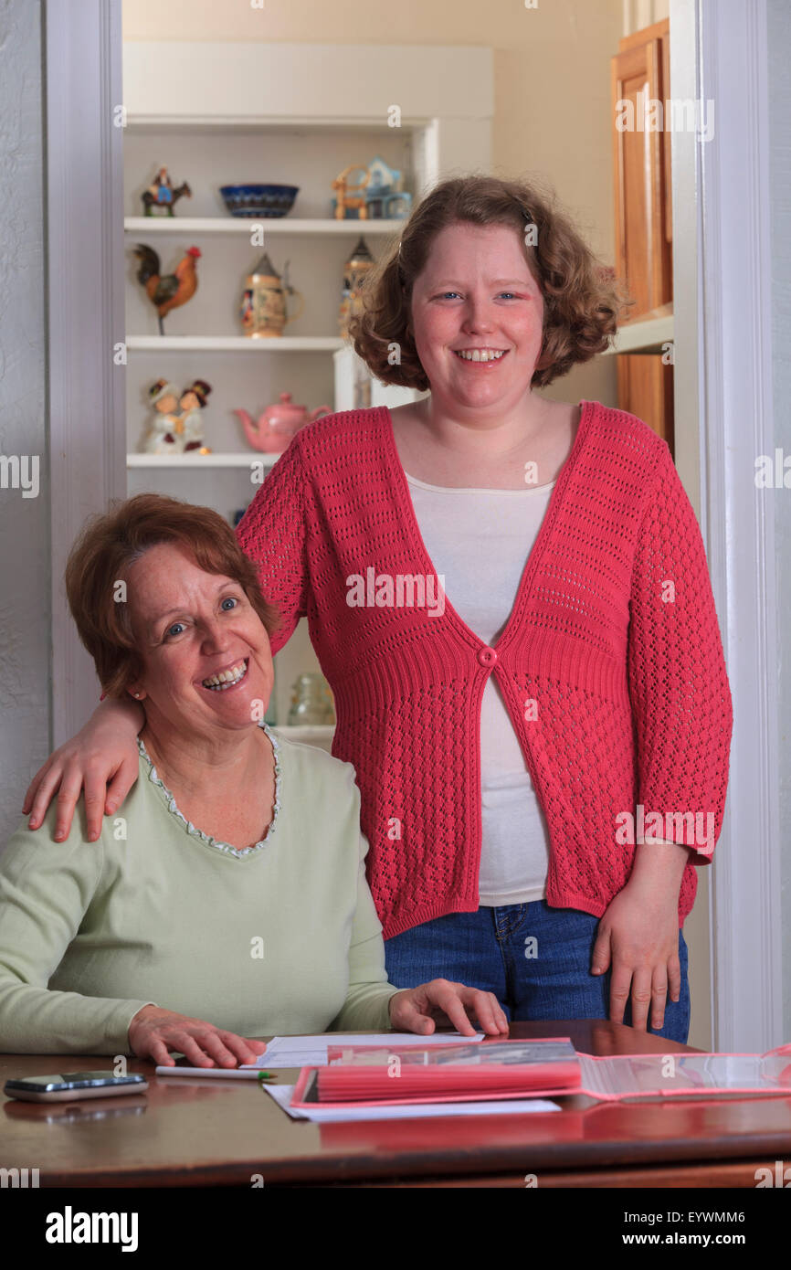 Mother helping daughter with Autism fill out job application Stock ...