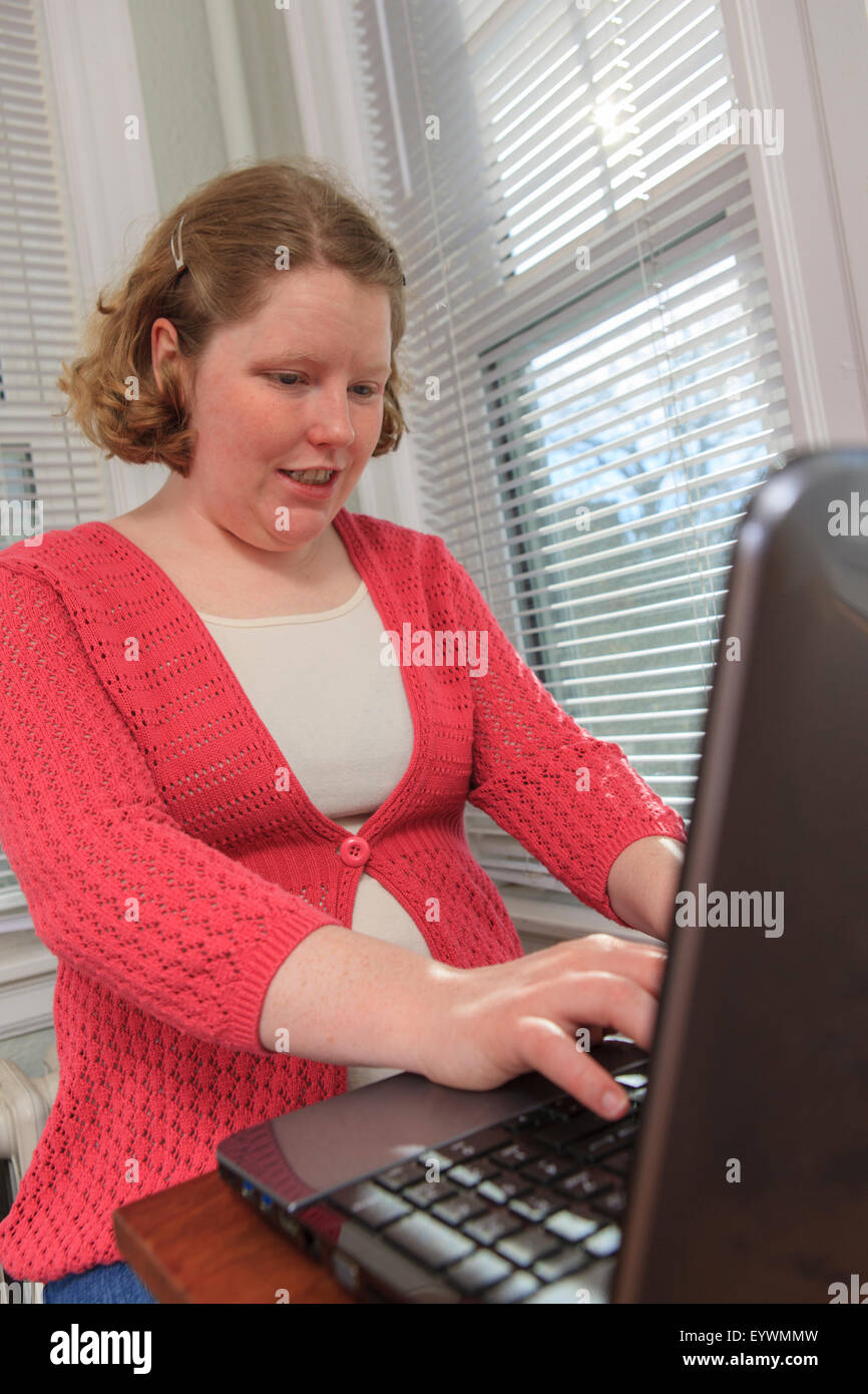 Young woman with Autism using her laptop Stock Photo - Alamy