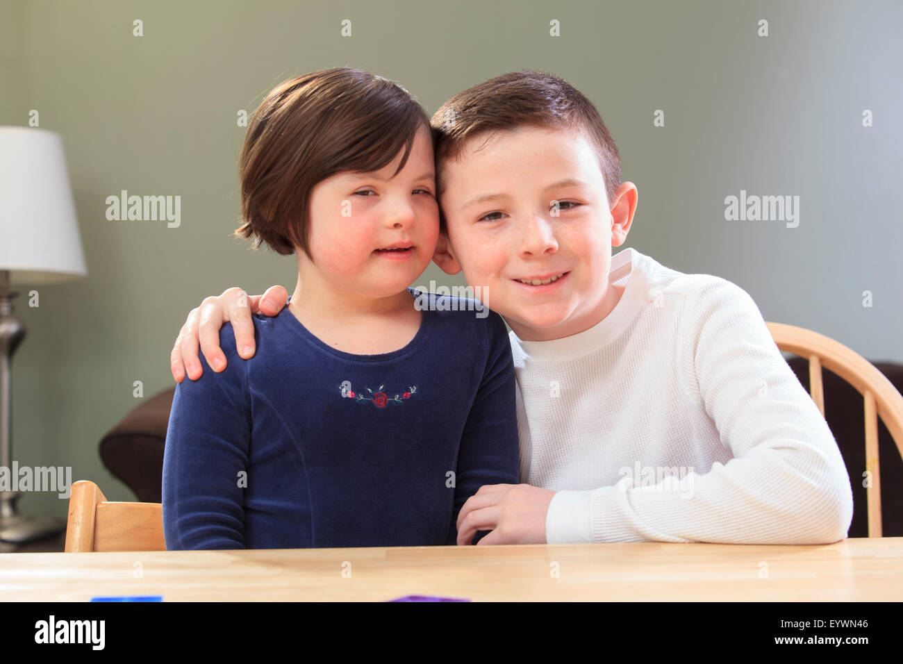 Little girl with Down Syndrome with her brother Stock Photo - Alamy