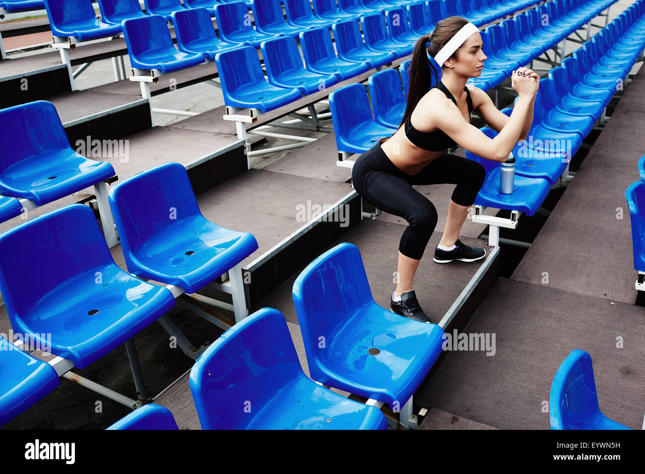Pretty female doing physical exercise at stadium Stock Photo - Alamy