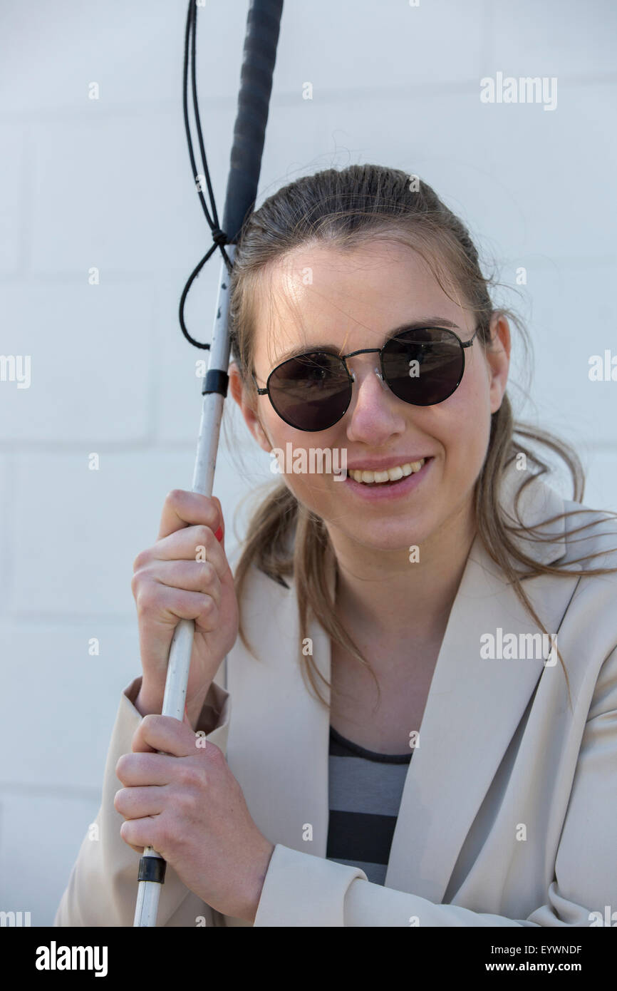 Young blind woman smiling with her cane Stock Photo - Alamy