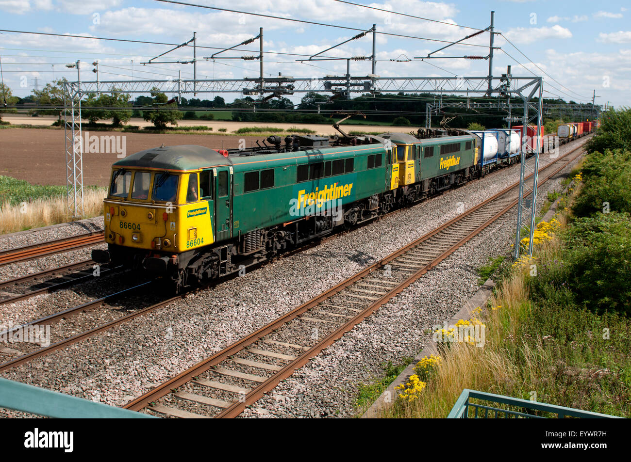 Two class 86 electric locomotives pulling an inter-modal freight train ...