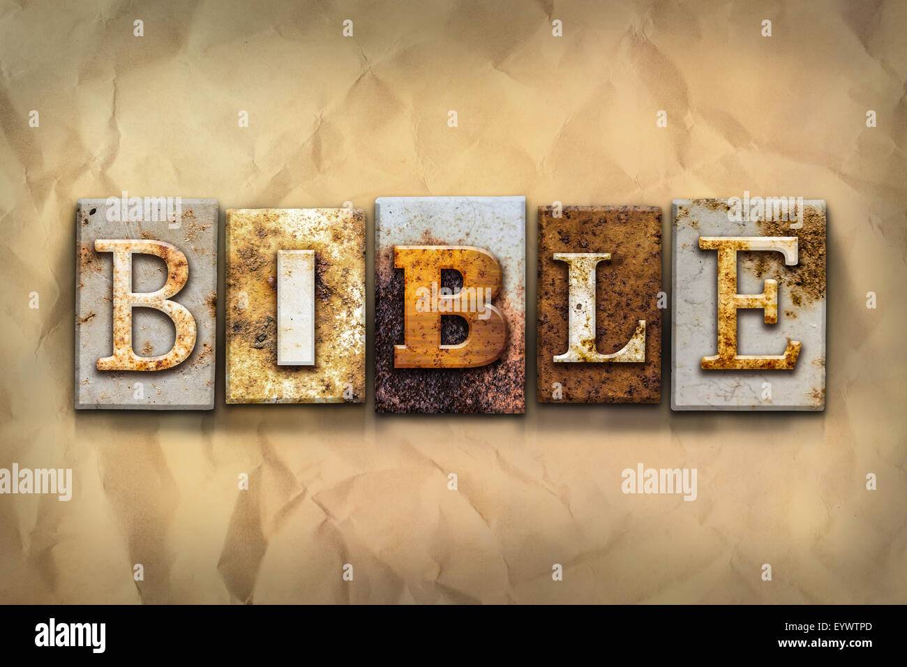 The word "BIBLE" written in rusty metal letterpress type on a crumbled ...