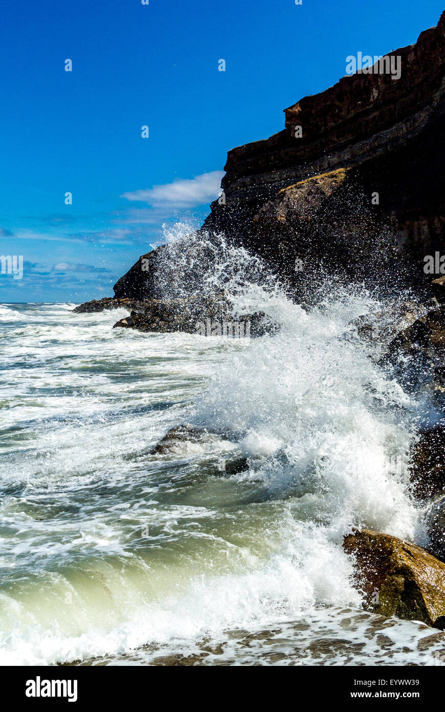 Ocean waves breaking onto rocks. Whitby Stock Photo - Alamy