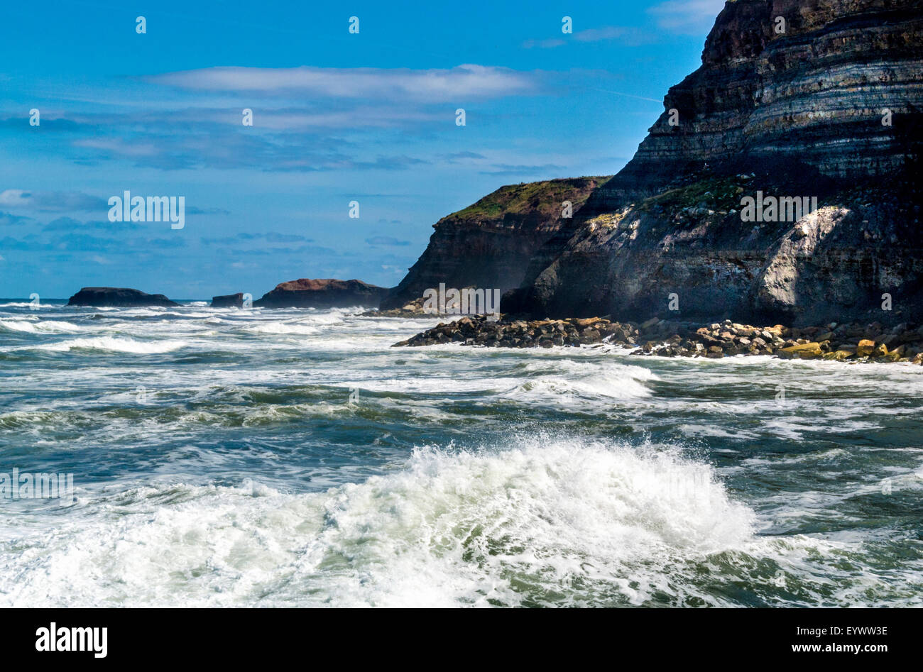 Ocean waves breaking onto rocks. Whitby. North Yorkshire Stock Photo ...