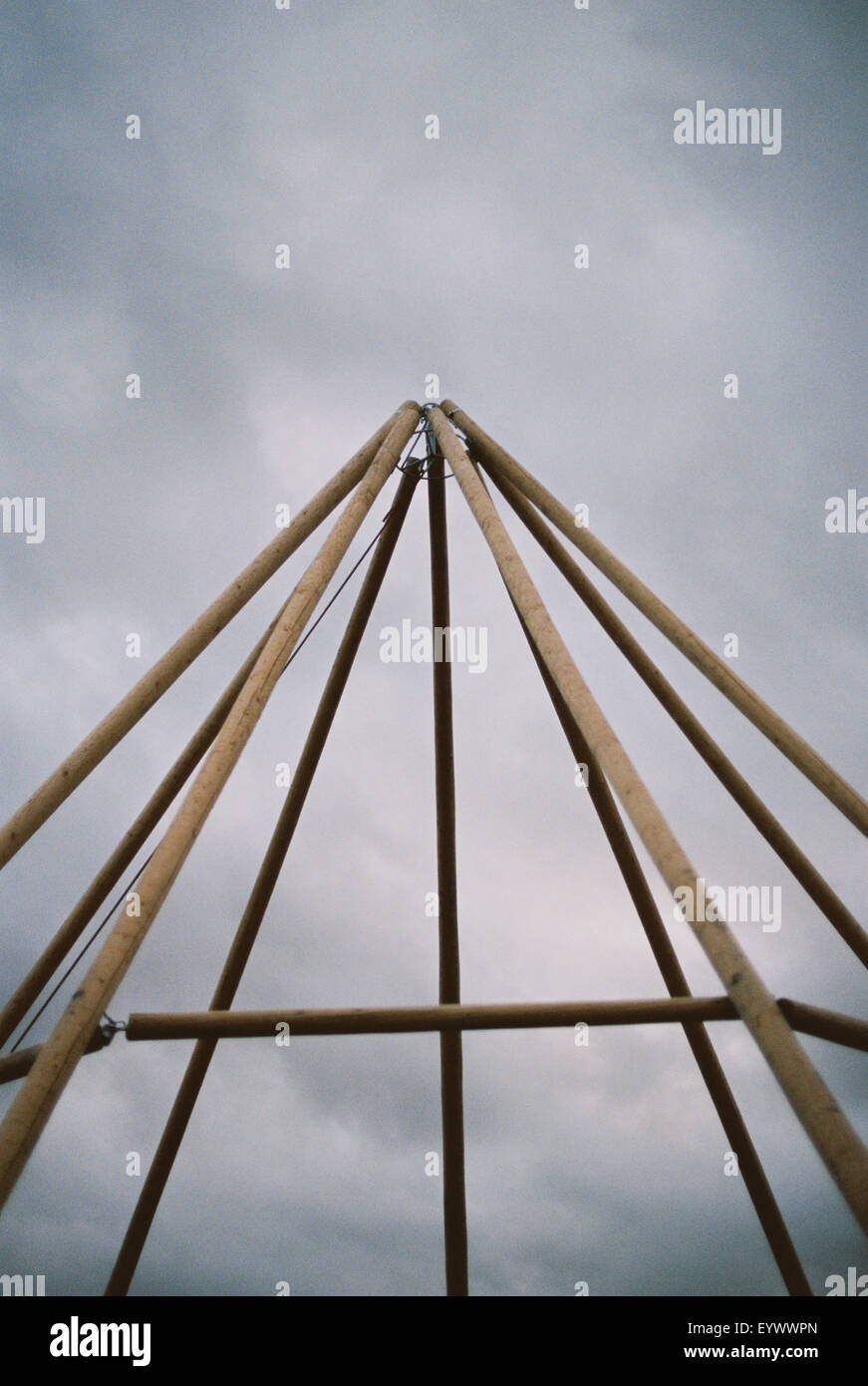 wooden tepee structure under an overcast sky Stock Photo - Alamy