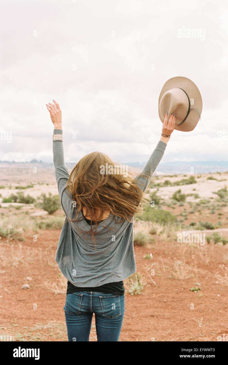 woman standing her arms raised up in the air Stock Photo - Alamy