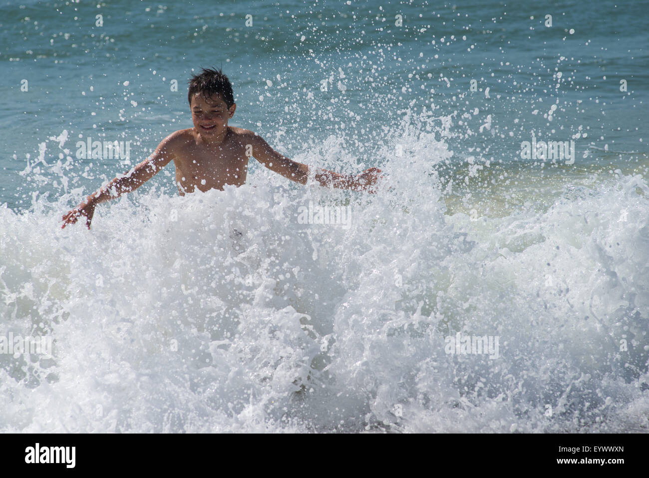 Children in waves hi-res stock photography and images - Alamy