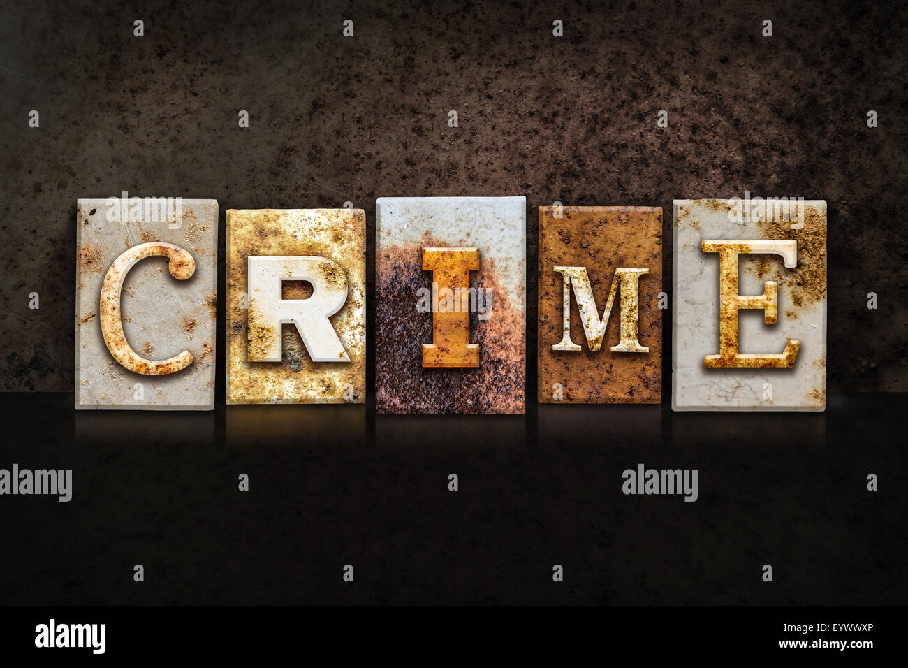The word "CRIME" written in rusty metal letterpress type on a dark ...