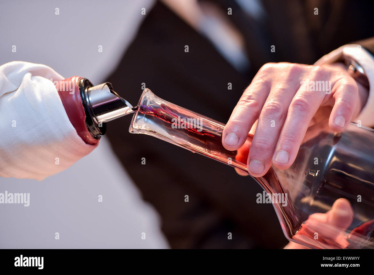 Decanting red wine - transferring wine to a carafe Stock Photo - Alamy