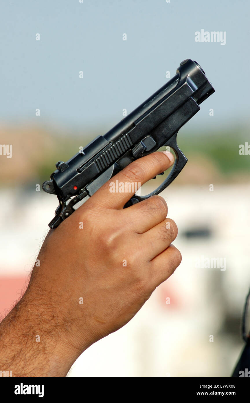 Revolver in man hand Stock Photo - Alamy