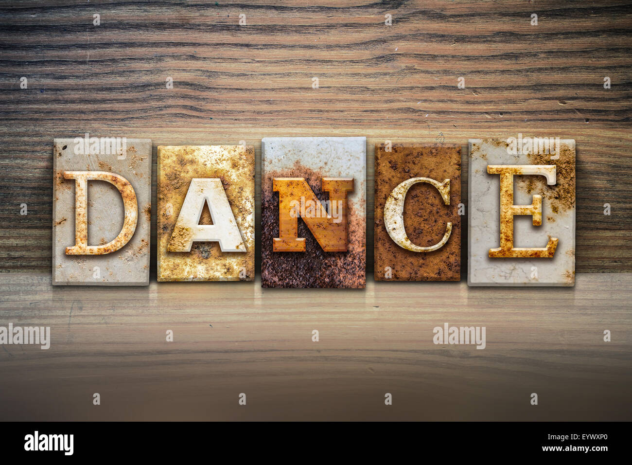 The word "DANCE" written in rusty metal letterpress type sitting on a ...