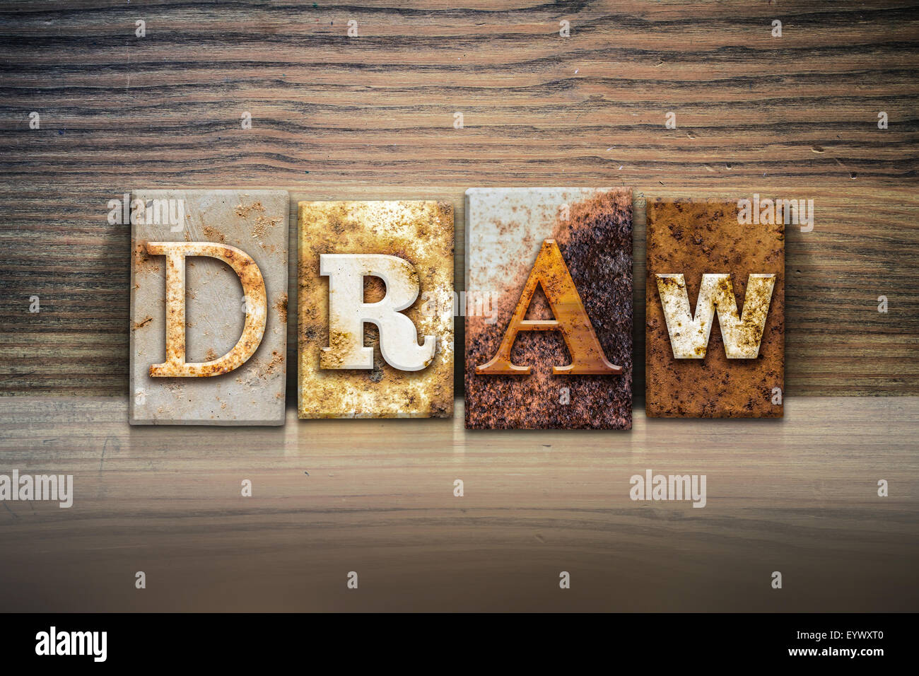The word "DRAW" written in rusty metal letterpress type sitting on a ...