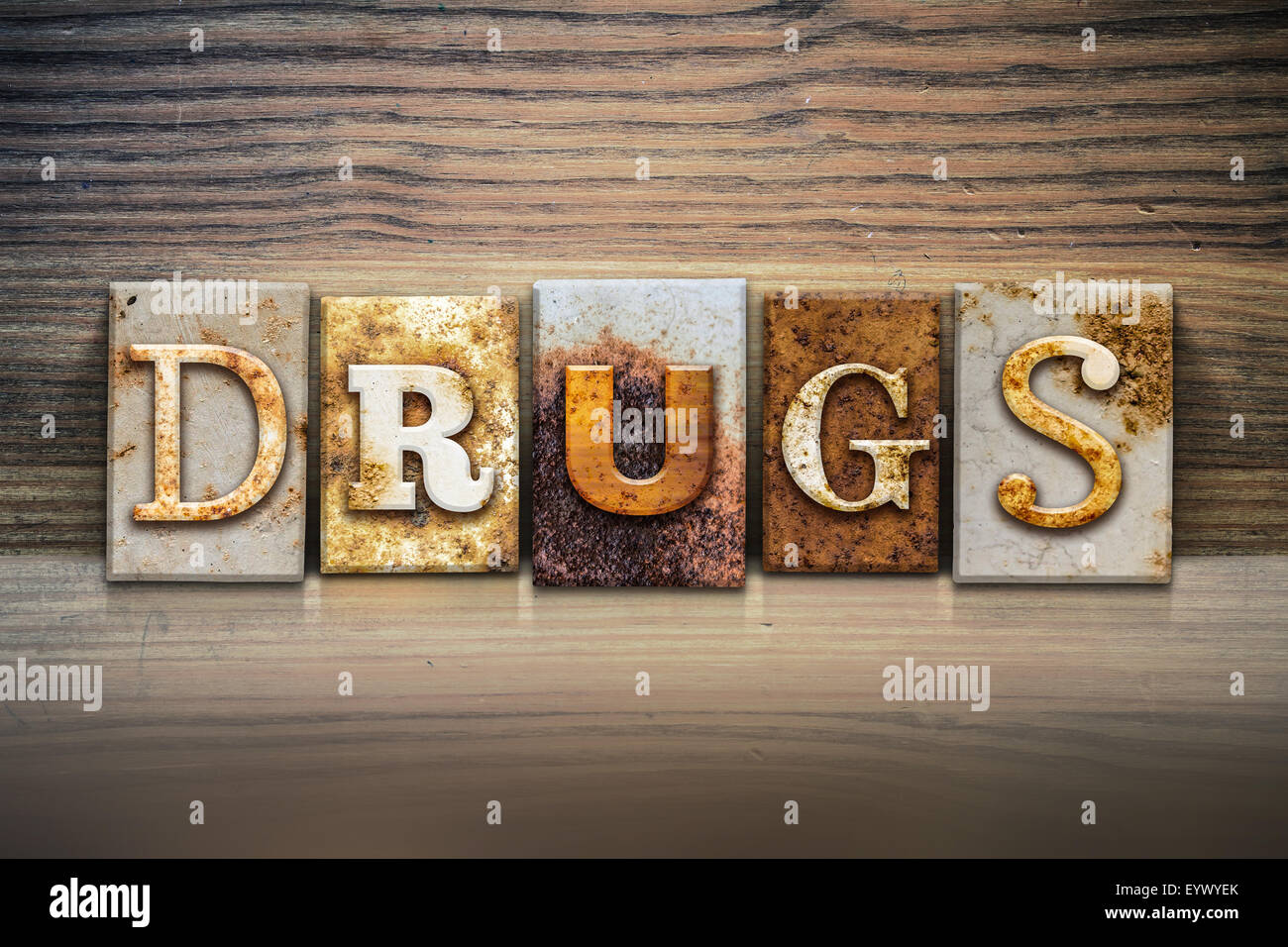 The word "DRUGS" written in rusty metal letterpress type sitting on a ...